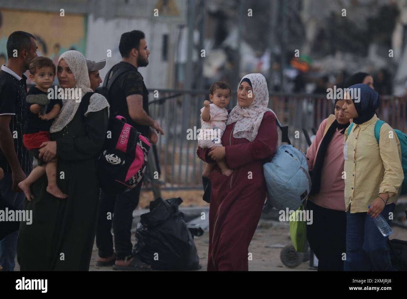 Palestinians carrying their personal belongings flee the al-Bureij ...