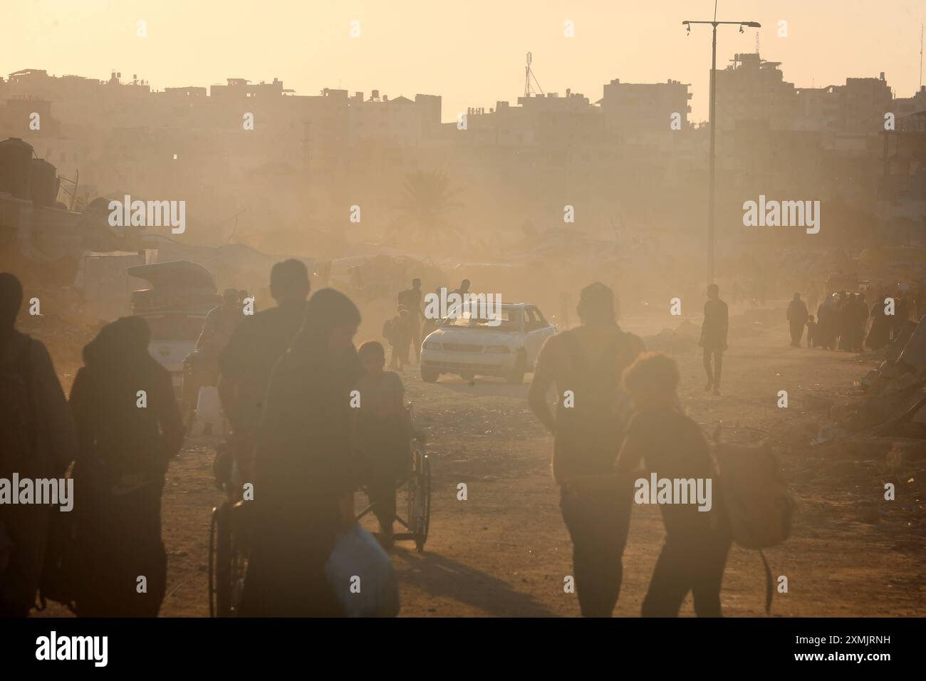 Palestinians carrying their personal belongings flee the al-Bureij ...