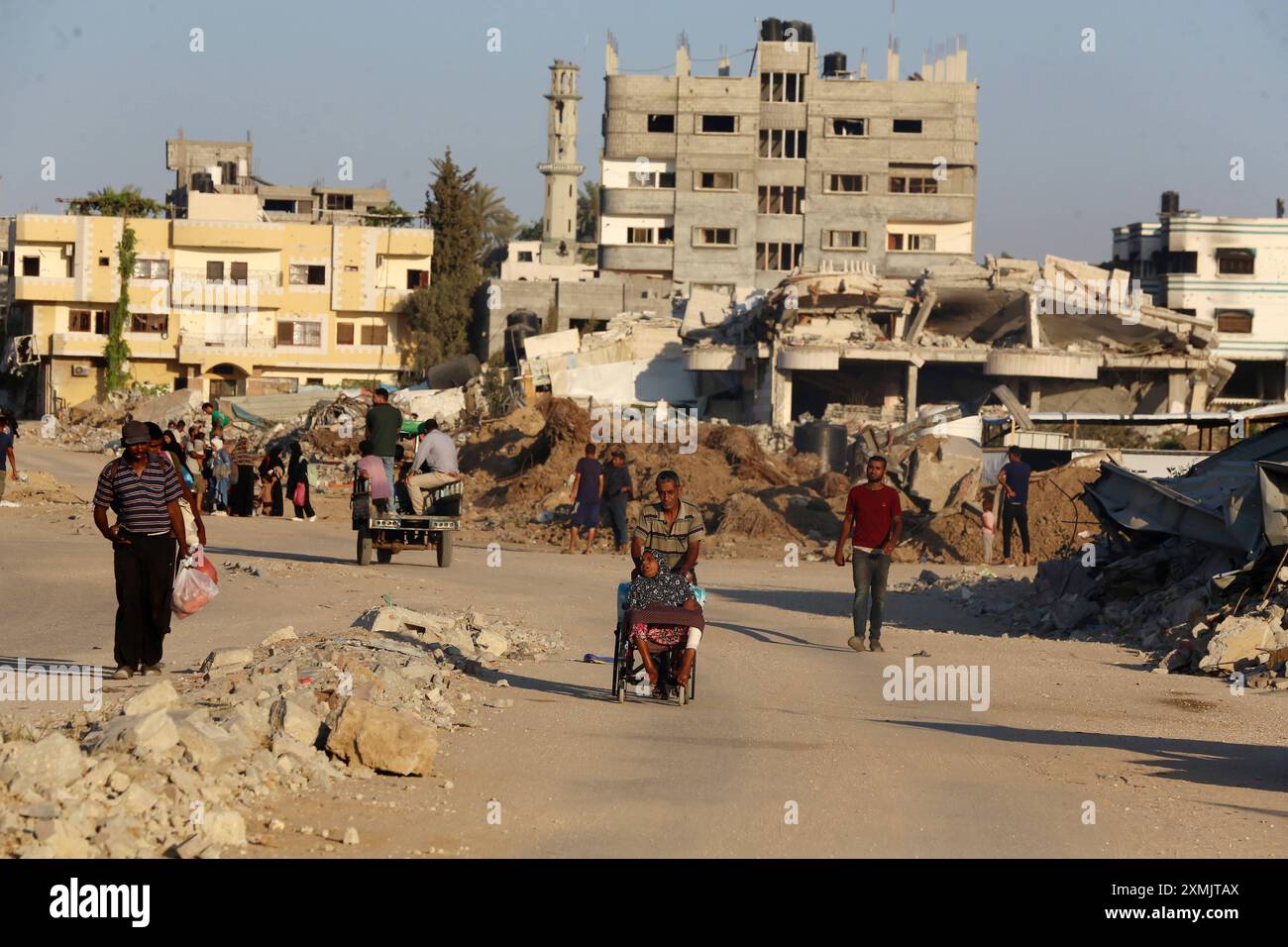 Palestinians carrying their personal belongings flee the al-Bureij ...