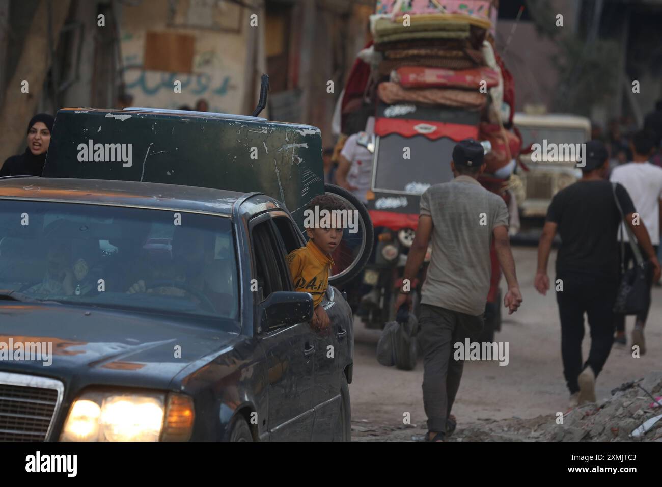 Palestinians carrying their personal belongings flee the al-Bureij ...