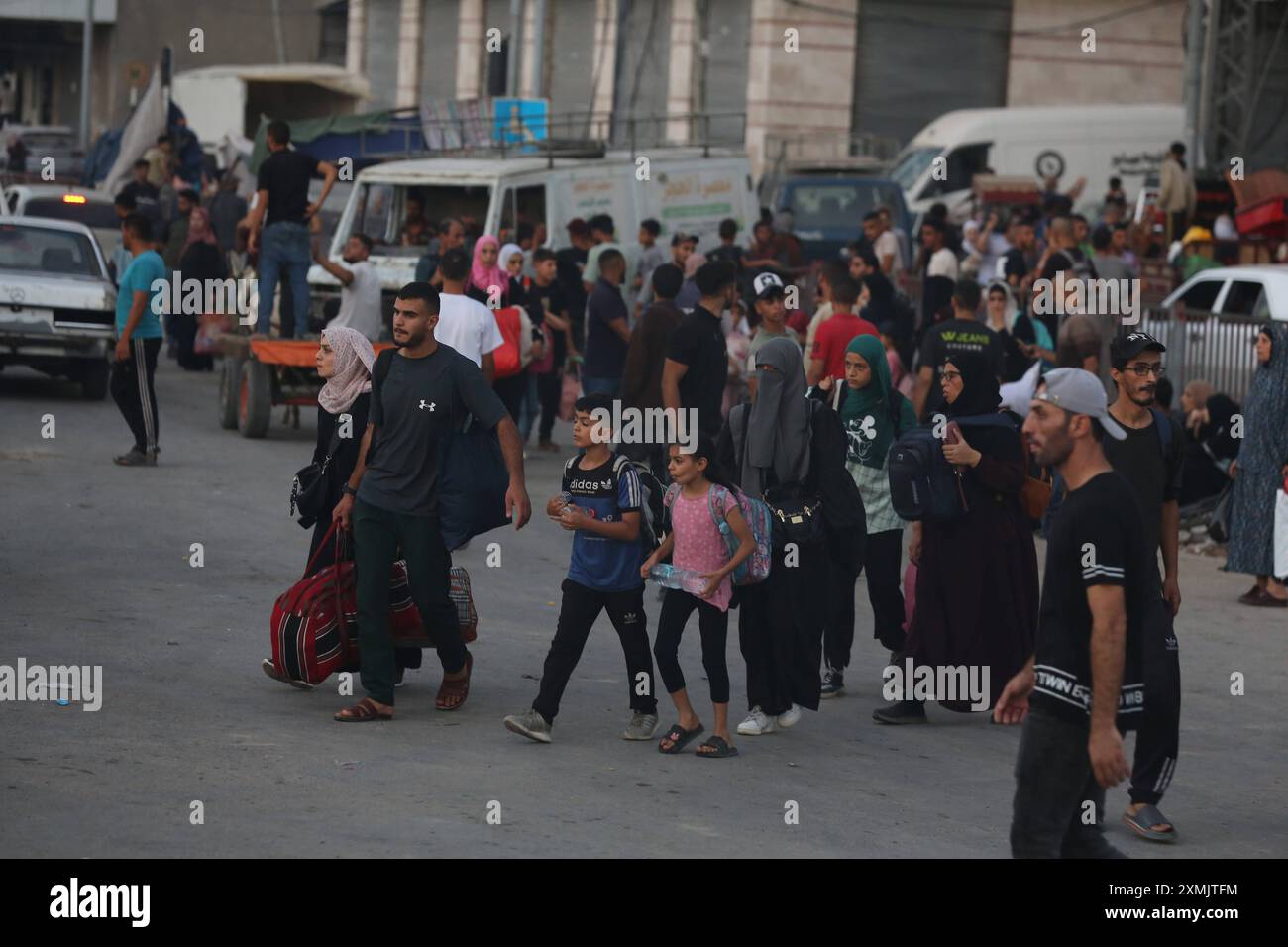 Palestinians carrying their personal belongings flee the al-Bureij ...