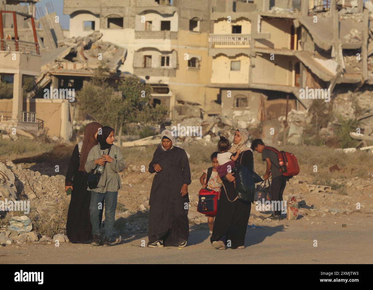 Palestinians carrying their personal belongings flee the al-Bureij ...