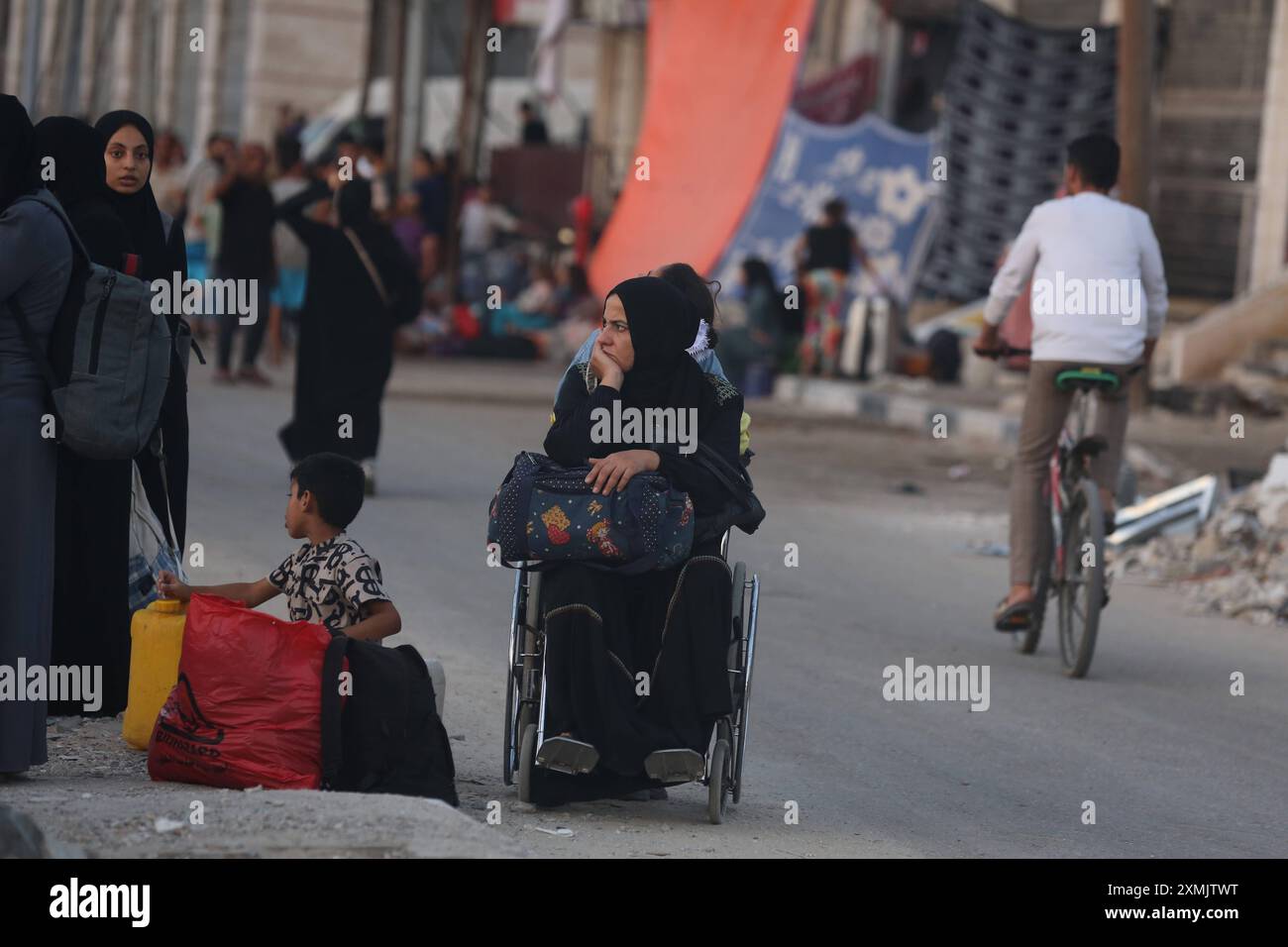 Palestinians carrying their personal belongings flee the al-Bureij ...