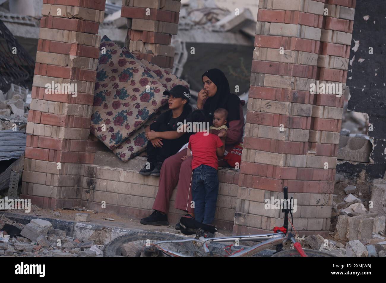 Palestinians carrying their personal belongings flee the al-Bureij ...