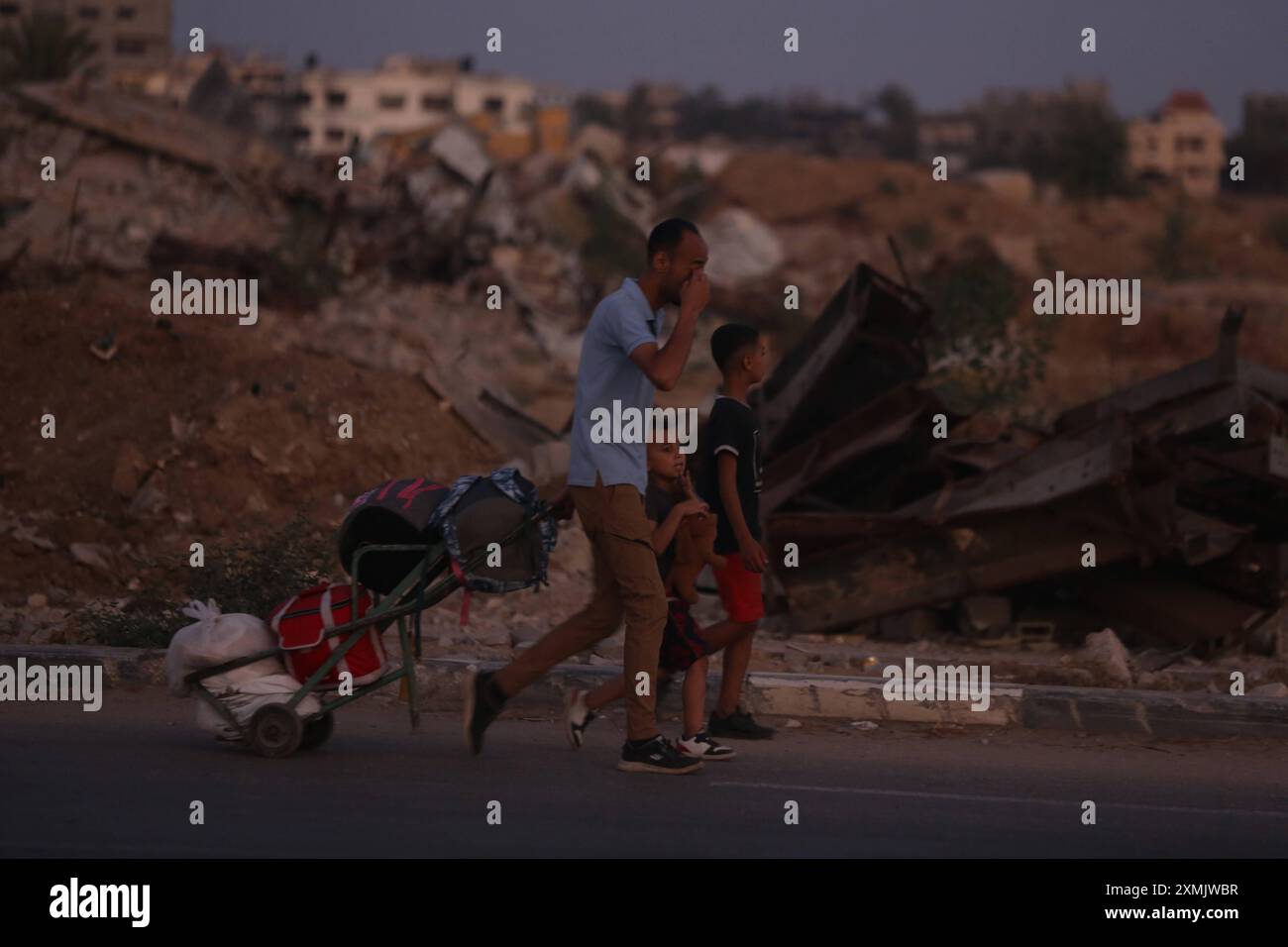 Palestinians carrying their personal belongings flee the al-Bureij ...