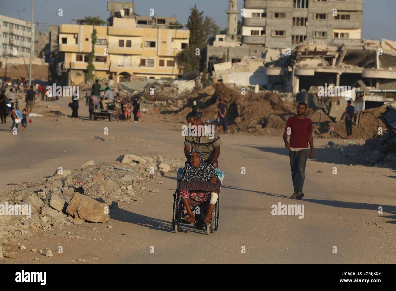 Palestinians carrying their personal belongings flee the al-Bureij ...