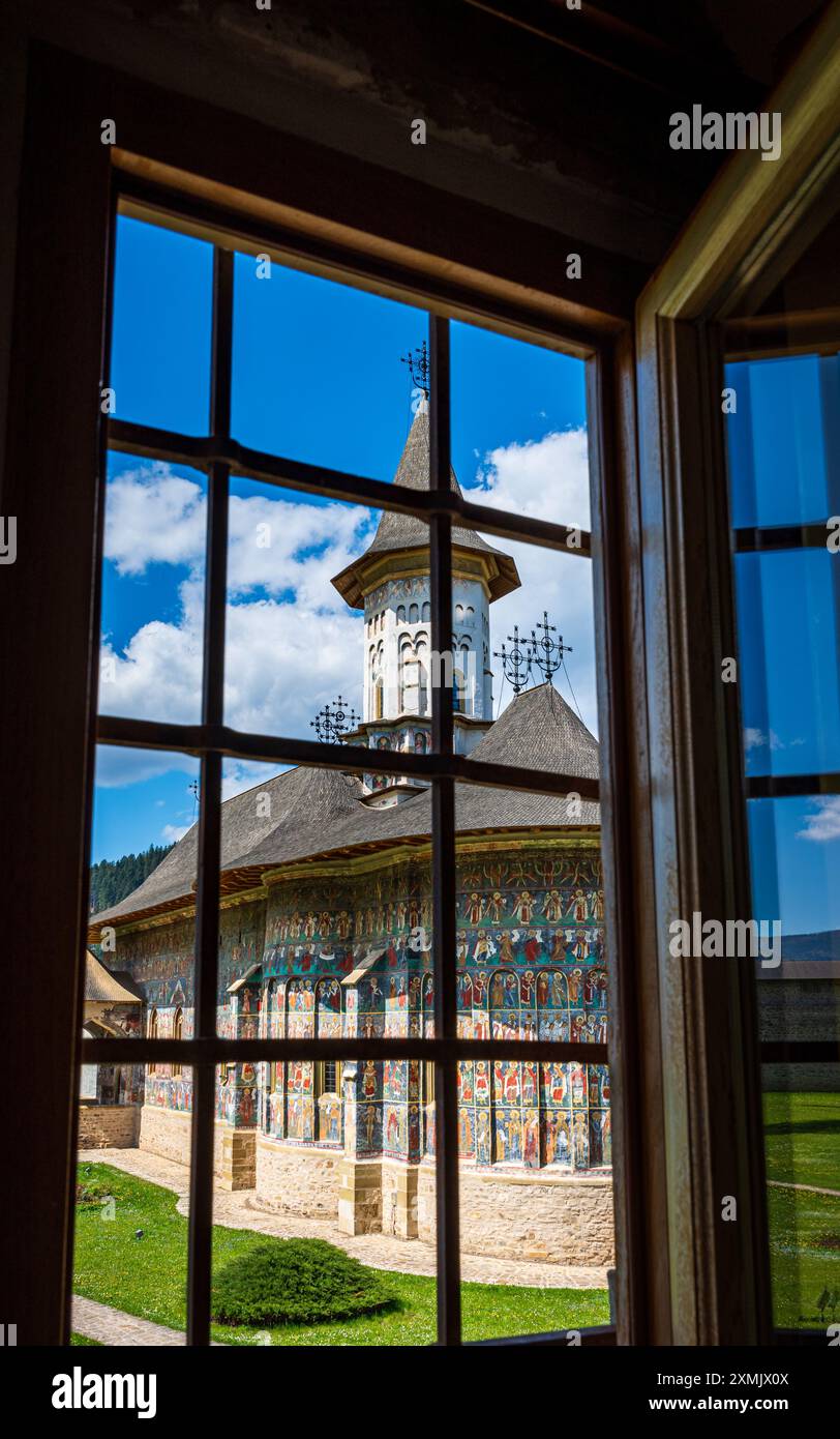 A unique perspective of a vibrant frescoed church tower, seen through ...