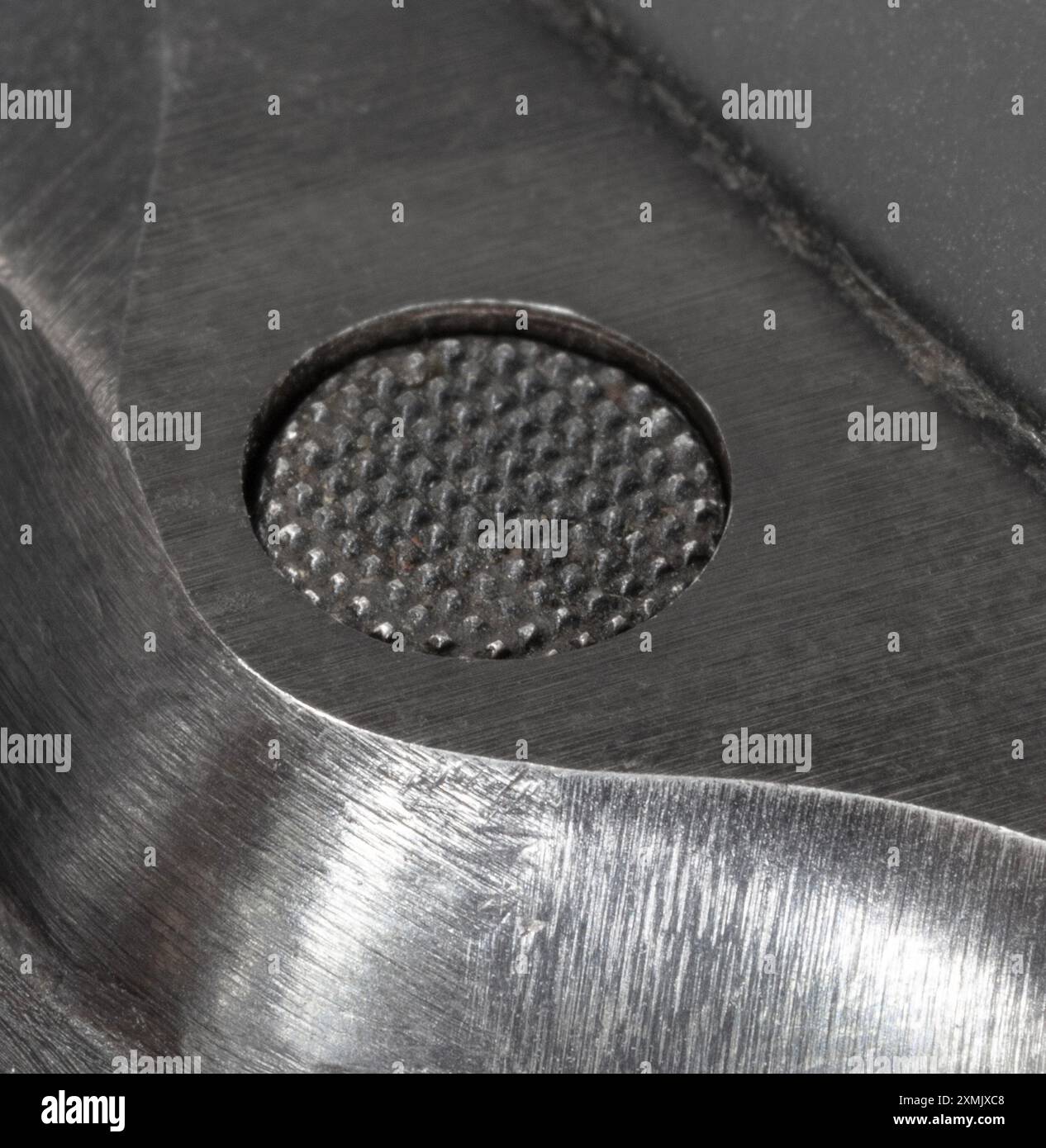 Magazine release button on a semi-auto pistol flush with the gun's ...