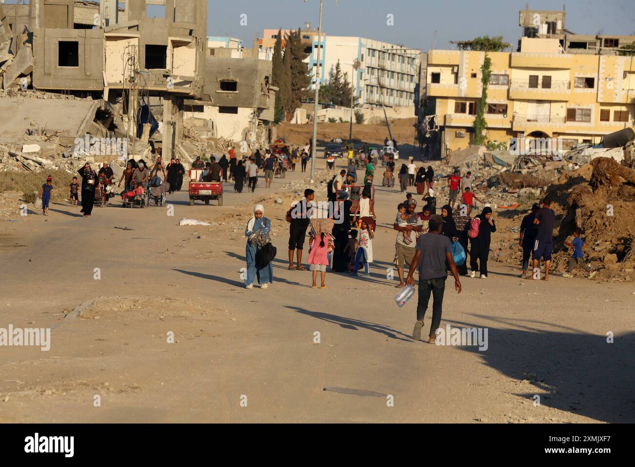 Palestinians carrying their personal belongings flee the al-Bureij ...