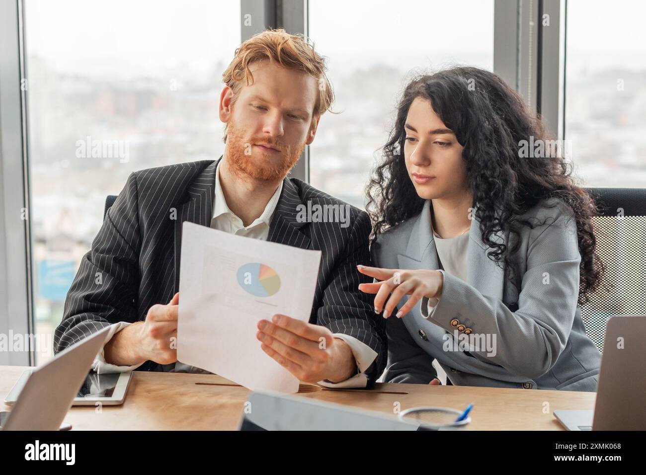 Business Partners Reviewing Pie Chart Data During Meeting Stock Photo ...