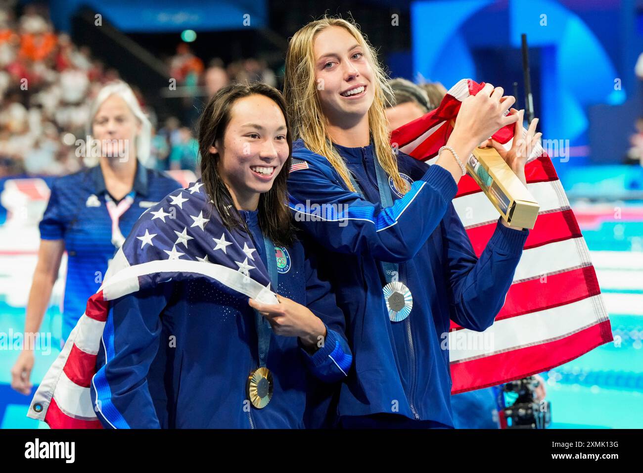 Gold medalist, Torri Huske, left, of the United States, walks with ...
