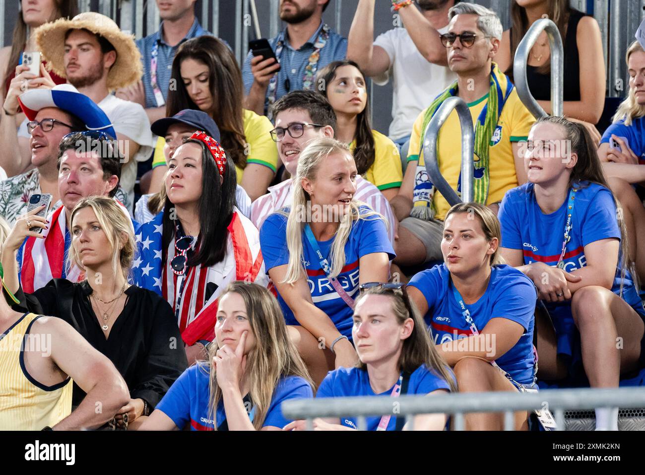 Players of the Norwegian women's handball team in the stands at the men ...