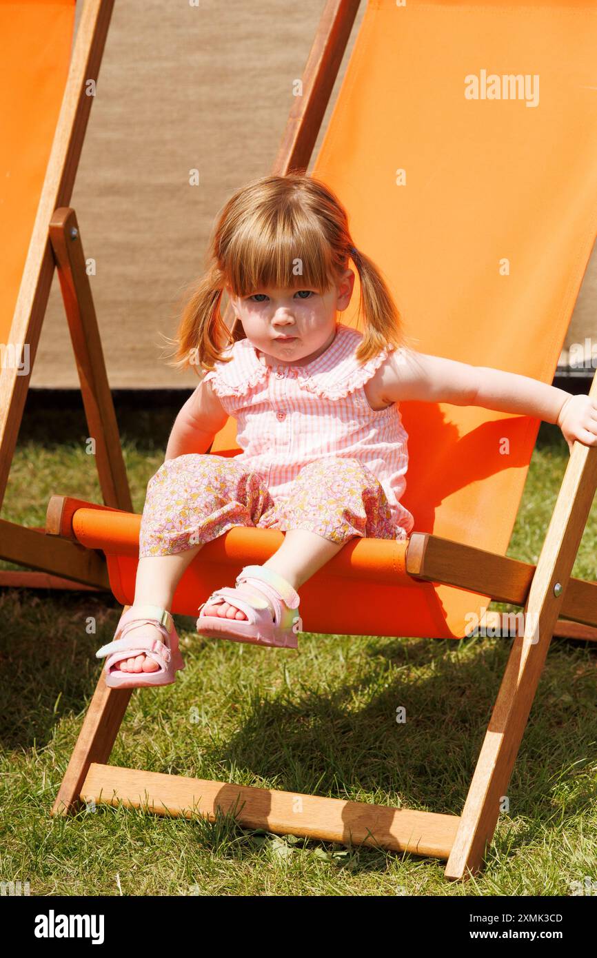 Little girl sitting in a deckchair at Lazydays Festival, Southend-on ...