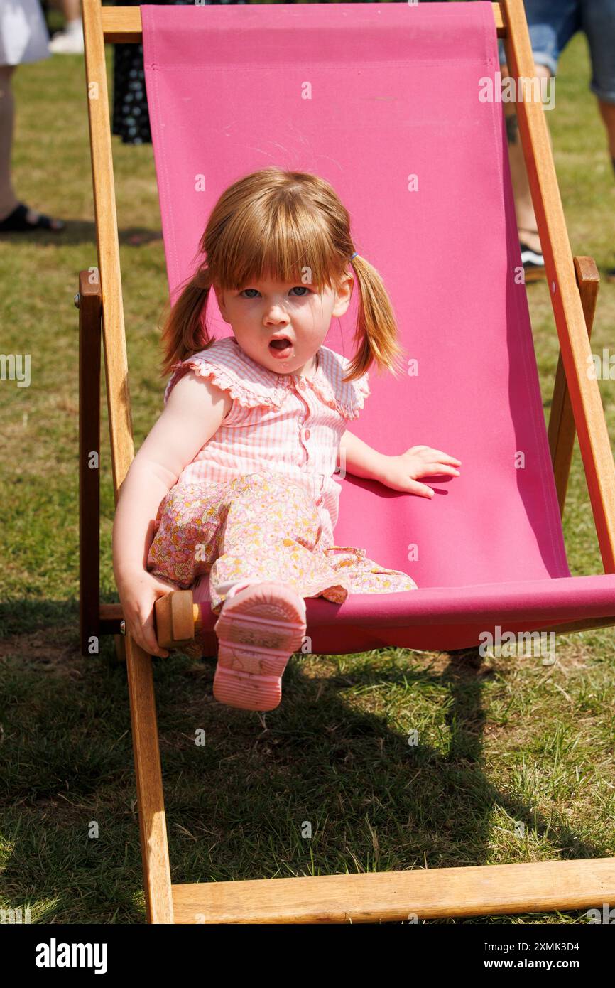 Little girl sitting in a deckchair at Lazydays Festival, Southend-on ...