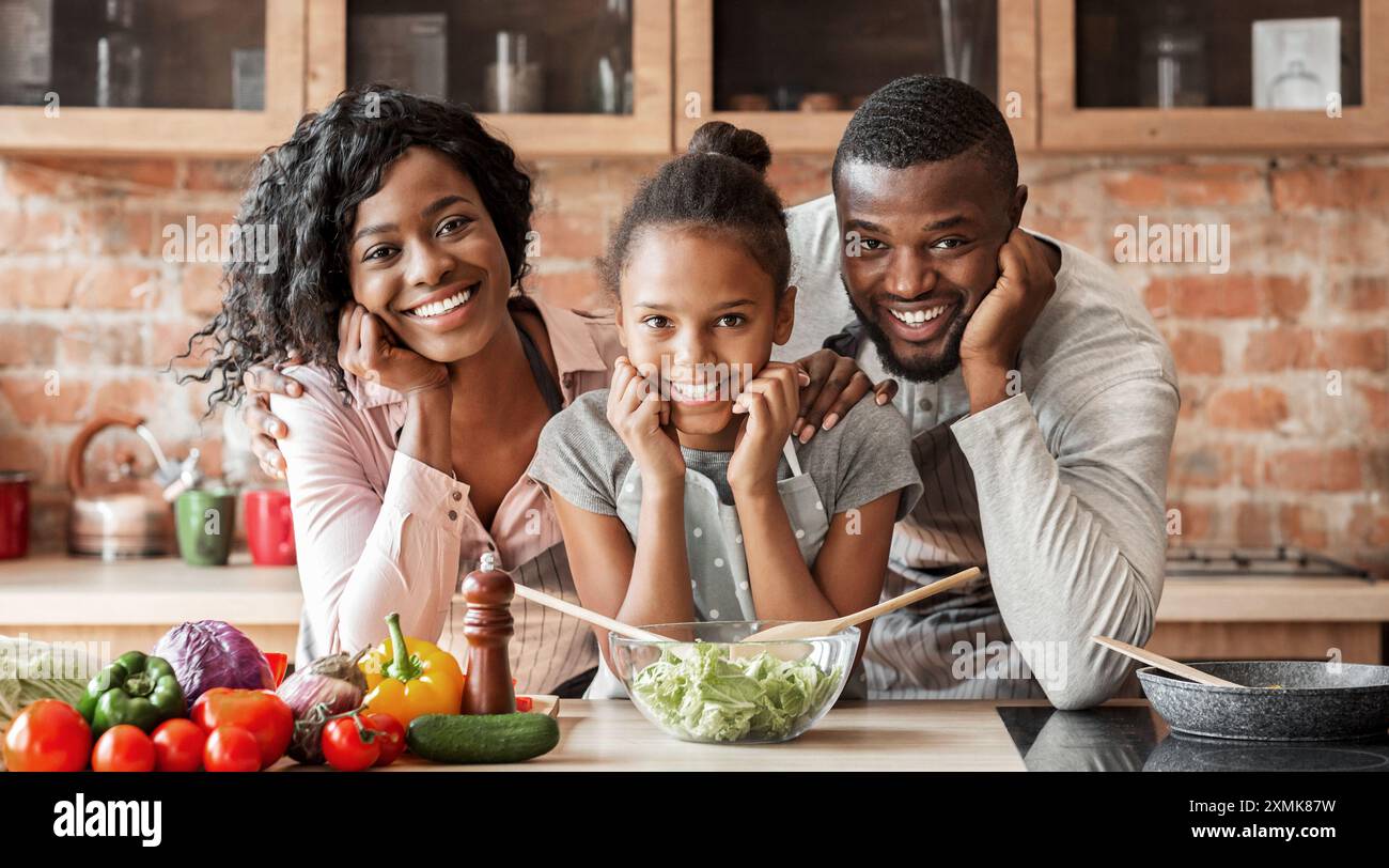 Adorable black family cooking healthy dinner together at kitchen Stock ...