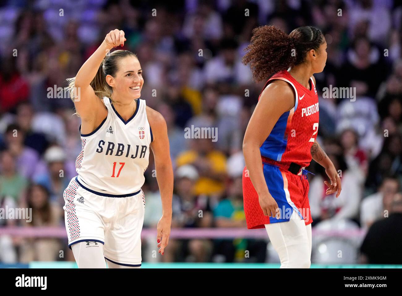 Jovana Nogic, left, of Serbia, gestures after scoring as Brianna Jones ...