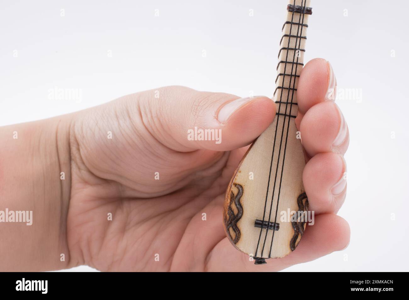 Hand holding turkish musical instrument saz on a white background Stock ...