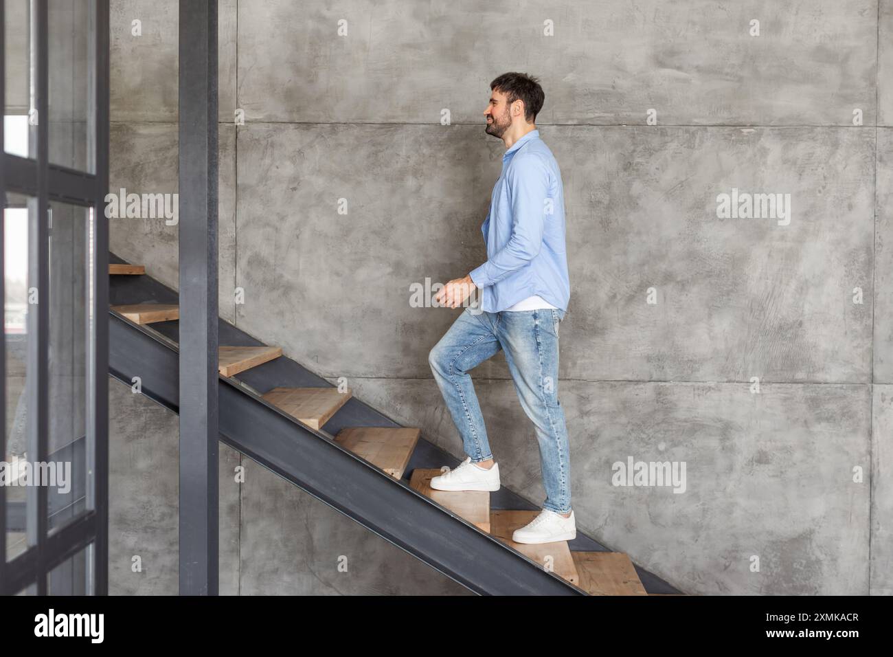 Man Walking Up Modern Interior Stairs At Home Stock Photo - Alamy
