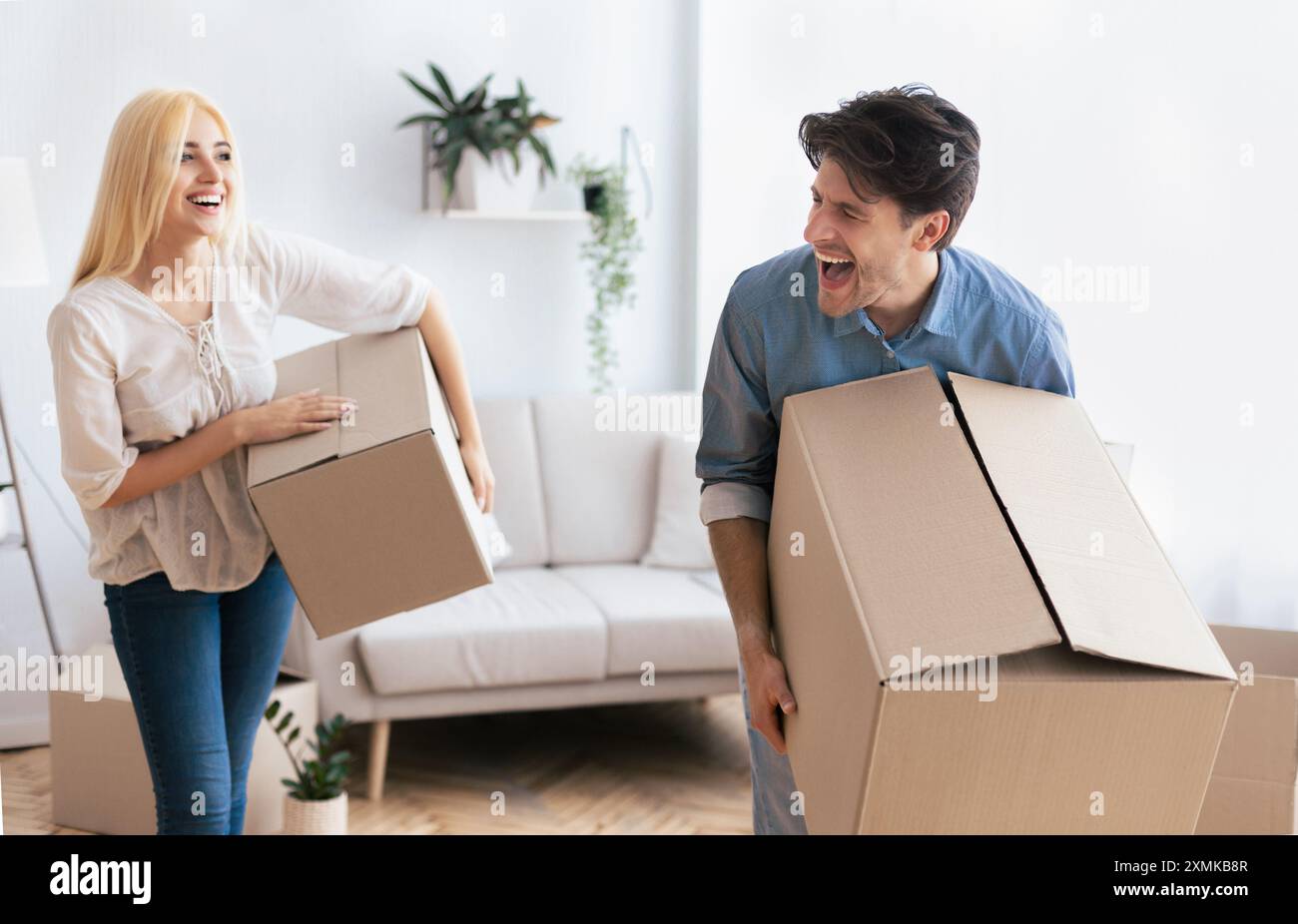 Couple Moving Boxes While Laughing Stock Photo - Alamy