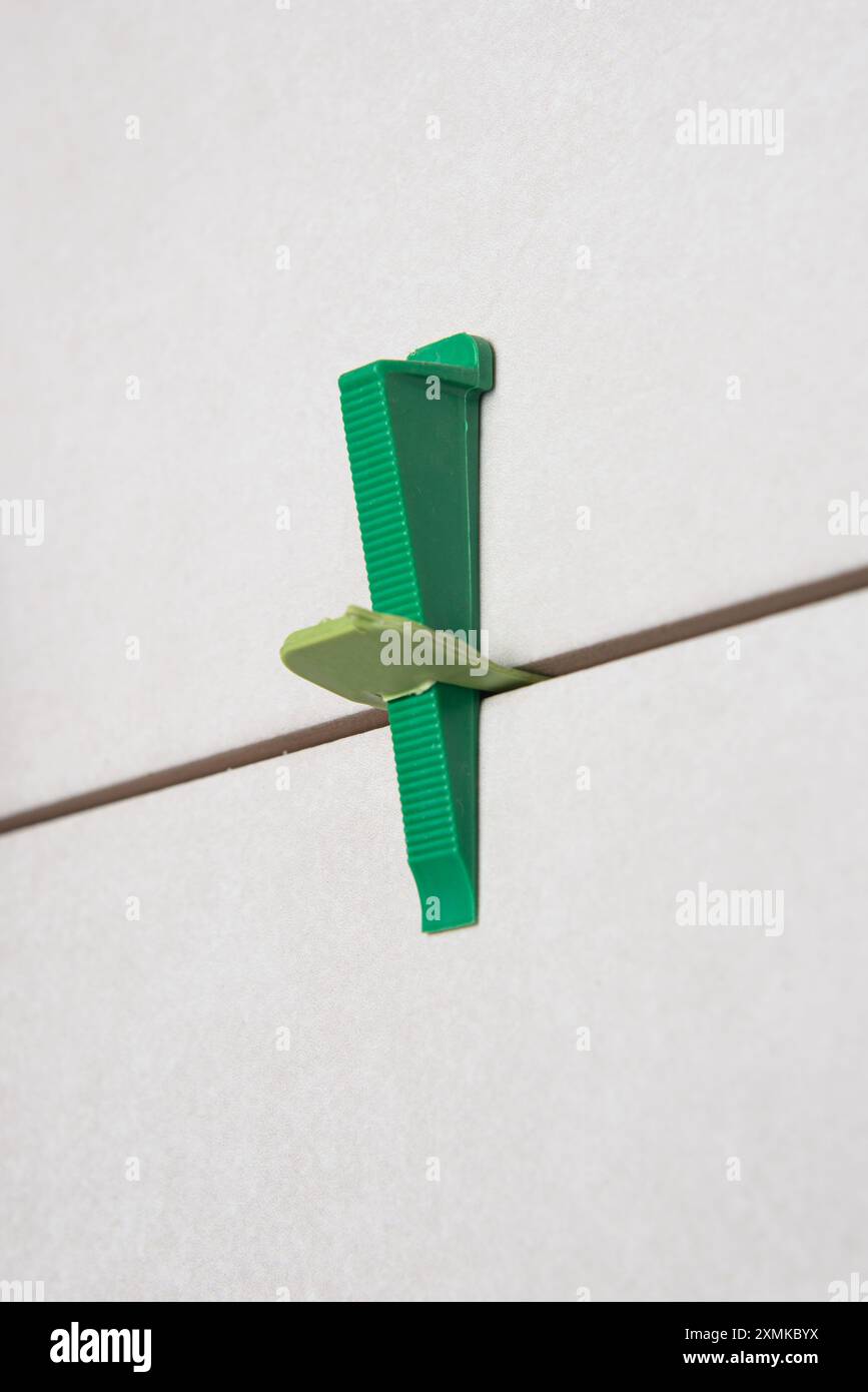 Tile leveling system with plastic clips and wedges Stock Photo - Alamy