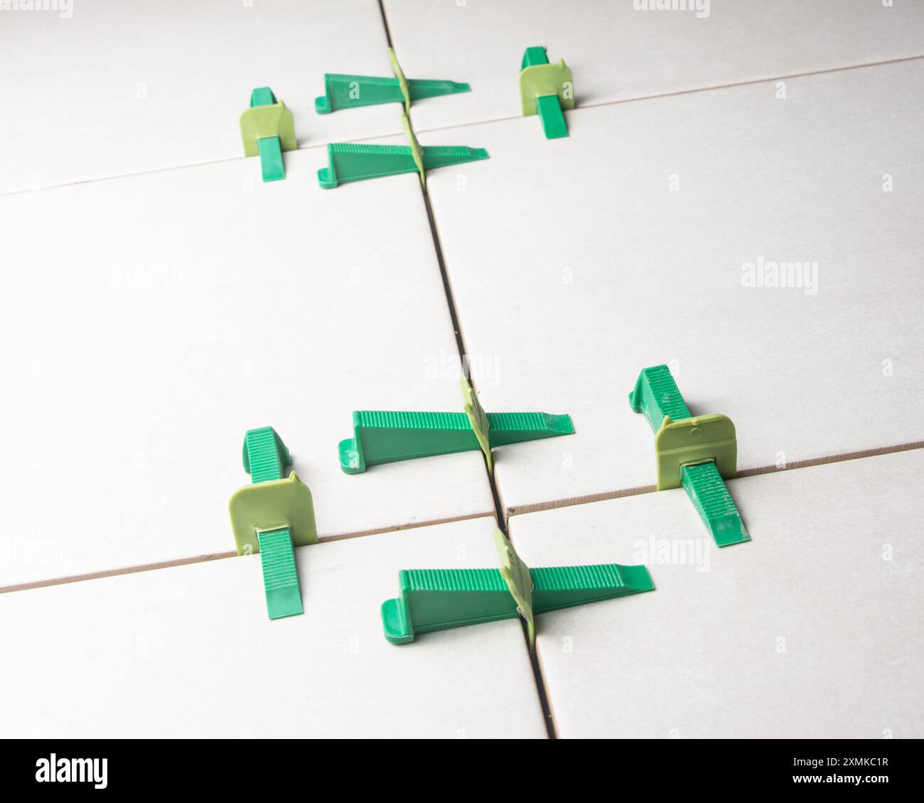 Tile leveling system with plastic clips and wedges Stock Photo - Alamy