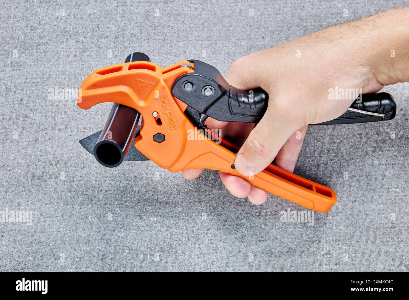 Ratcheting pipe cutter in shape of scissors with polyethylene tube on ...