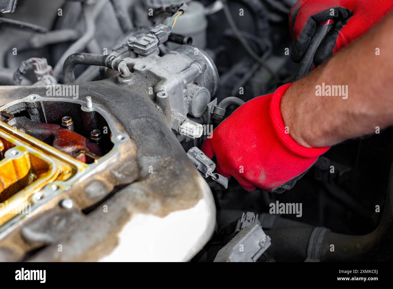 Car repair. A mechanic repairs a gas distribution mechanism by removing ...