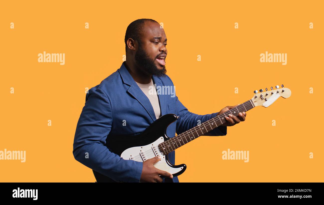 Man holding guitar, excited to perform rock tunes during concert ...