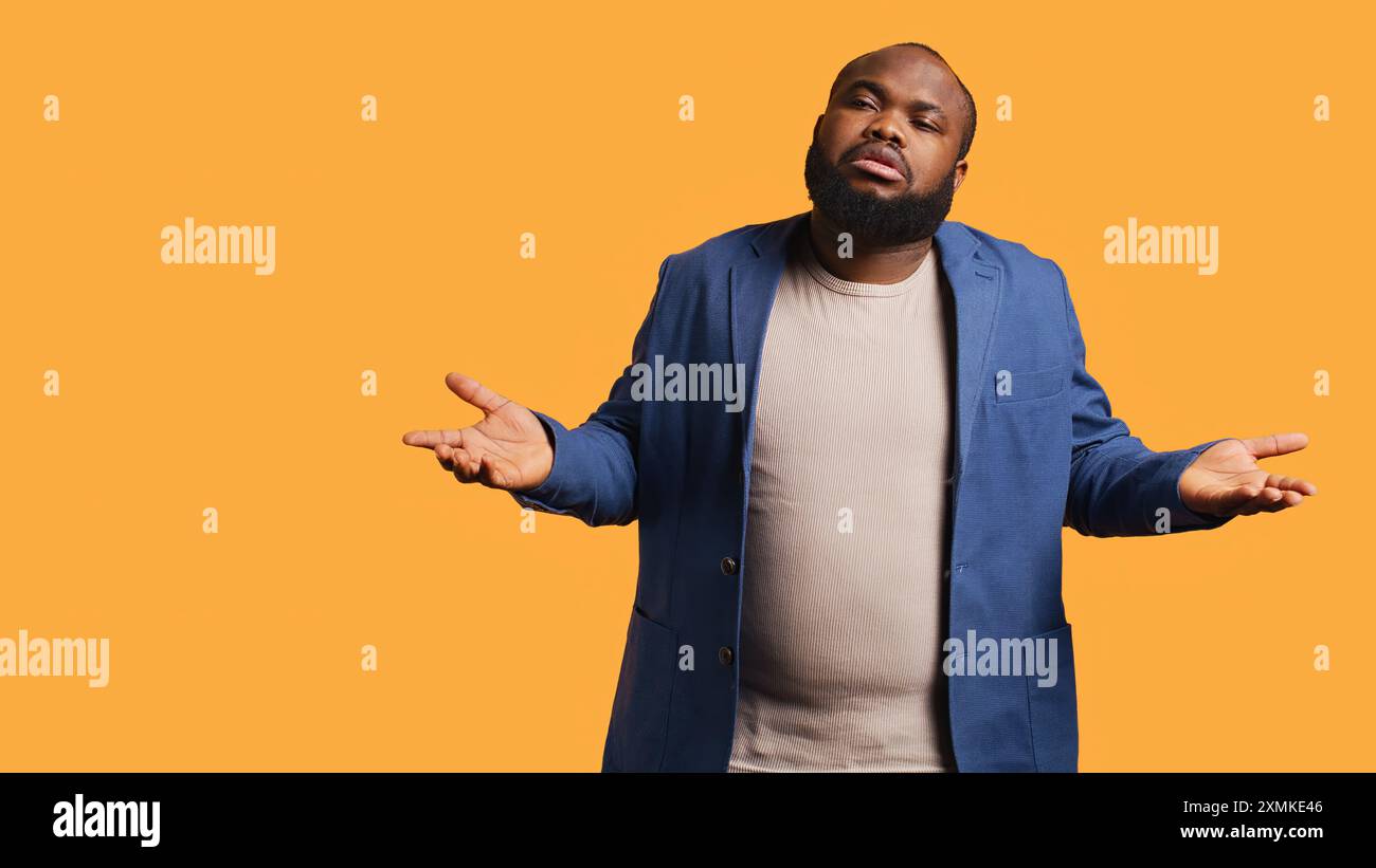 African american man shrugging shoulders, not caring, having detached ...