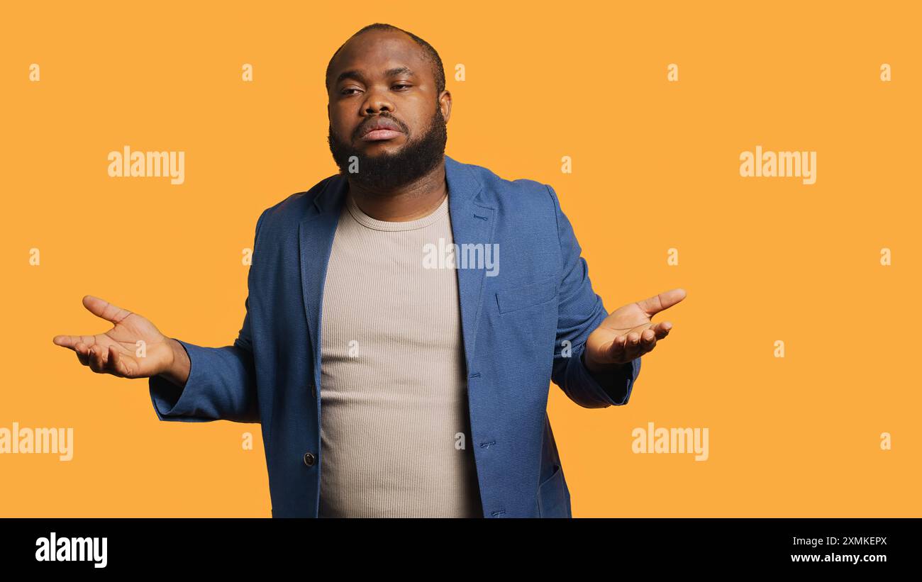 African american man shrugging shoulders, not caring, having detached ...