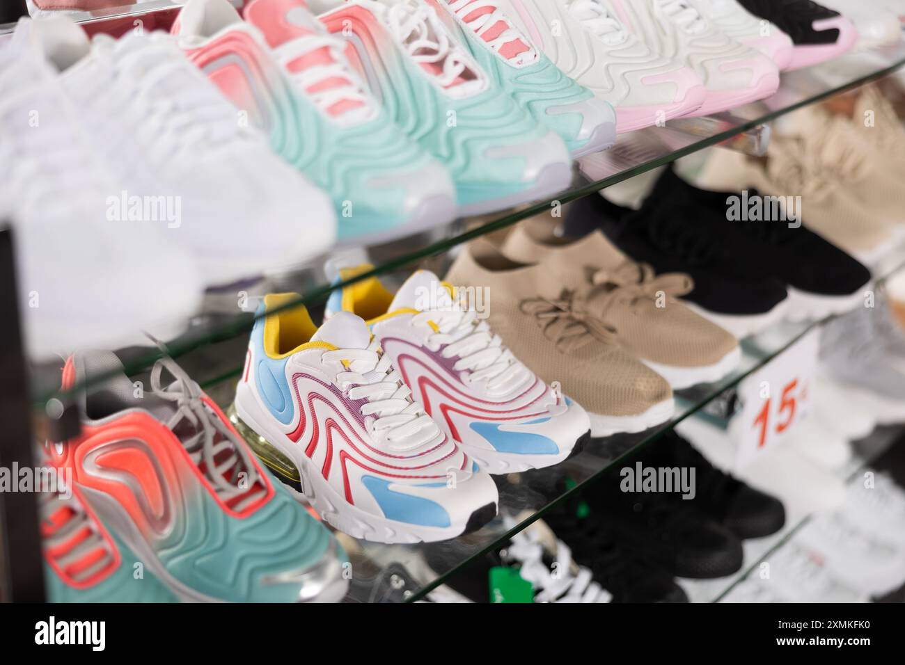 Showcase with models of sneakers in shoe store Stock Photo - Alamy