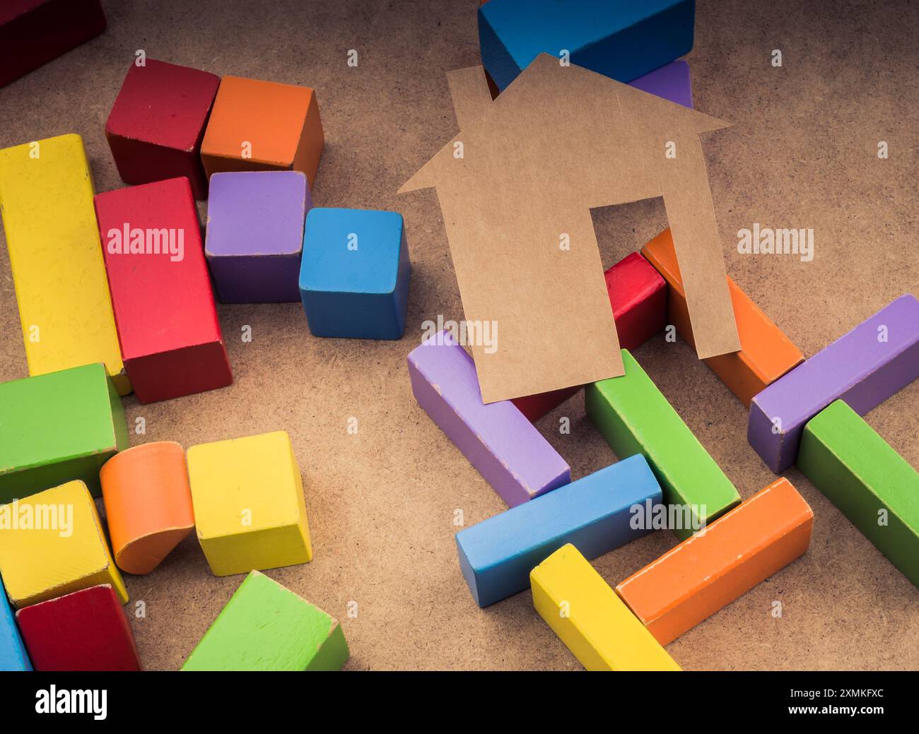 House shape formed out of building blocks on a brown background Stock ...