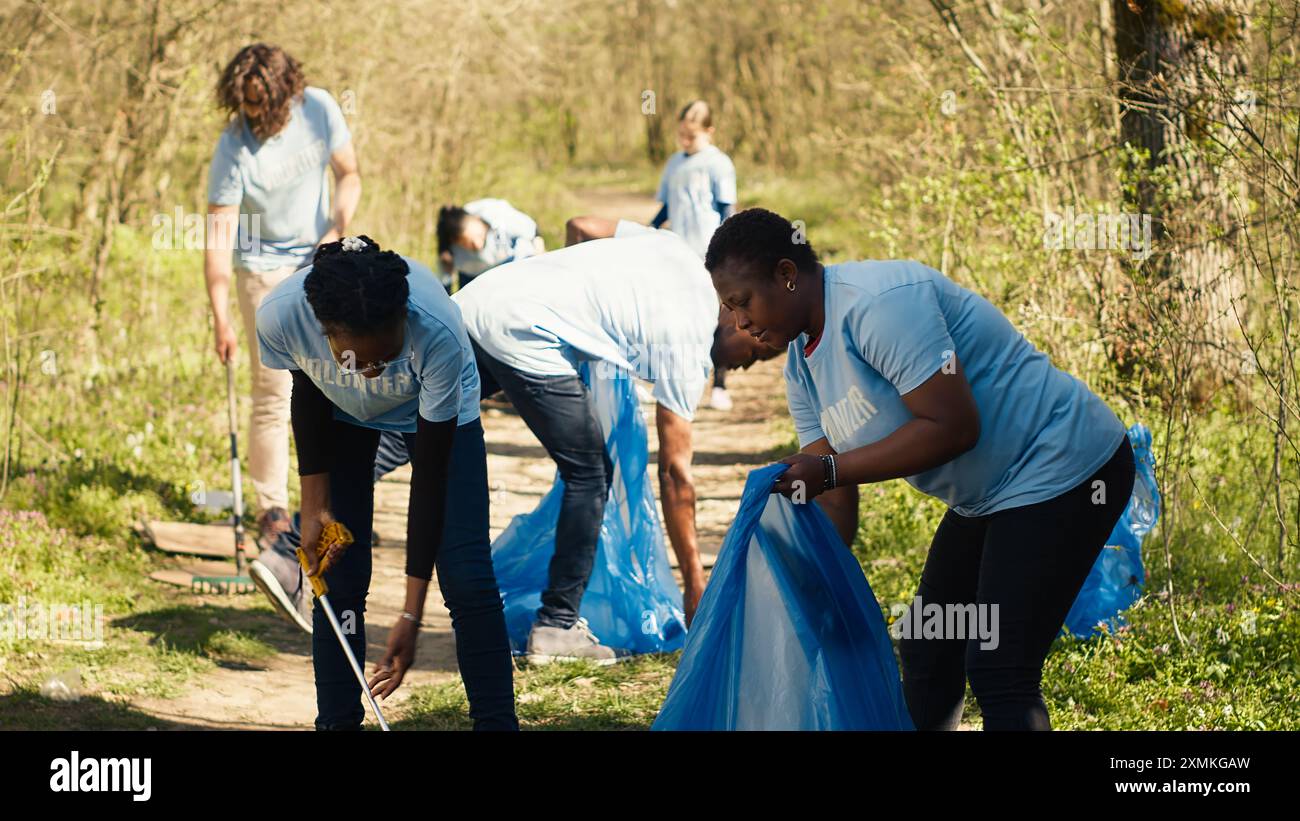 Women collecting waste in forest hi-res stock photography and images ...
