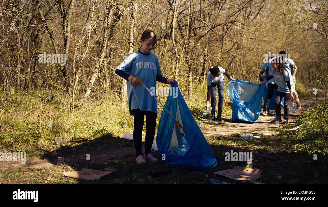 Small girl collecting rubbish hi-res stock photography and images - Alamy