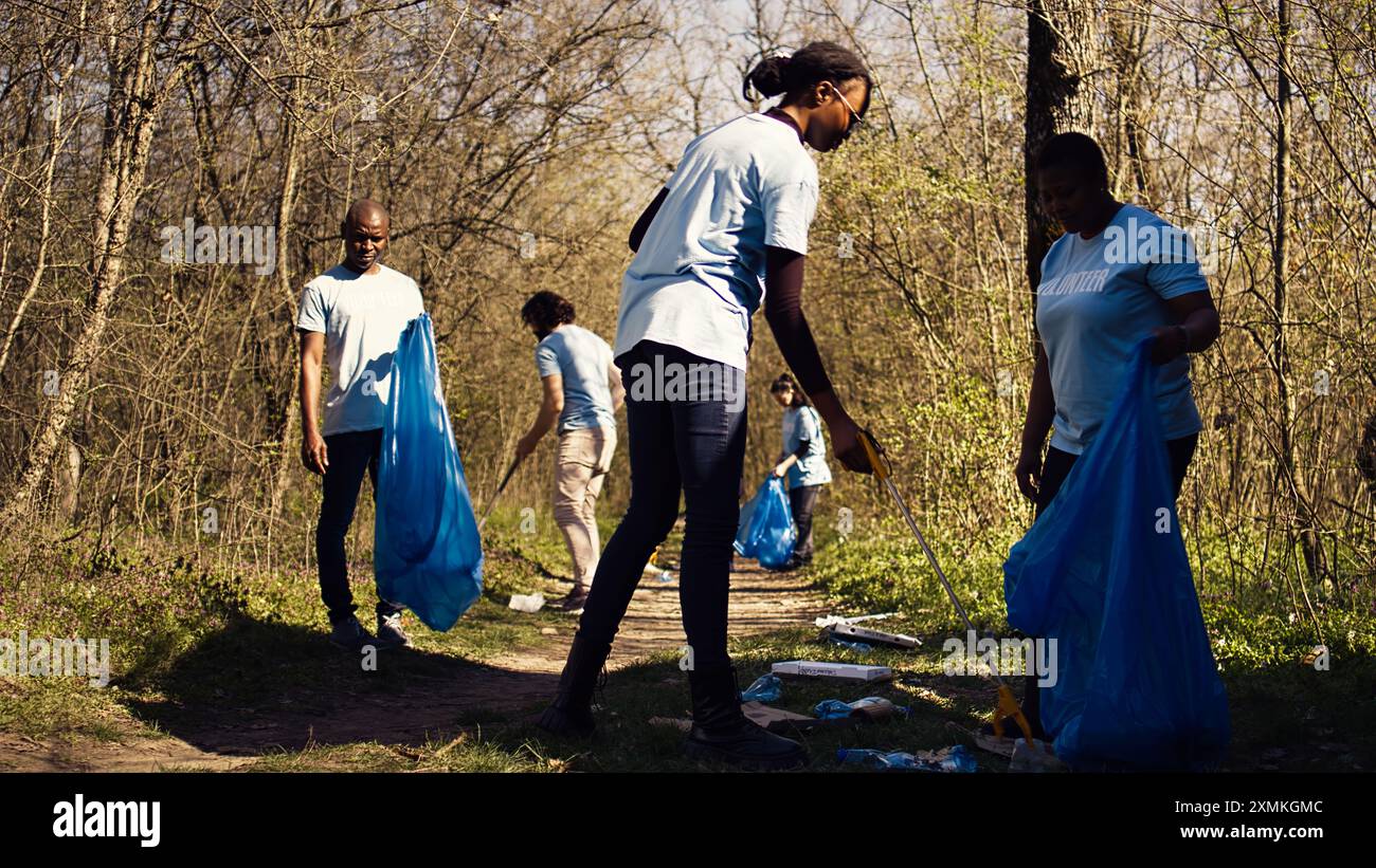 Women collecting waste in forest hi-res stock photography and images ...