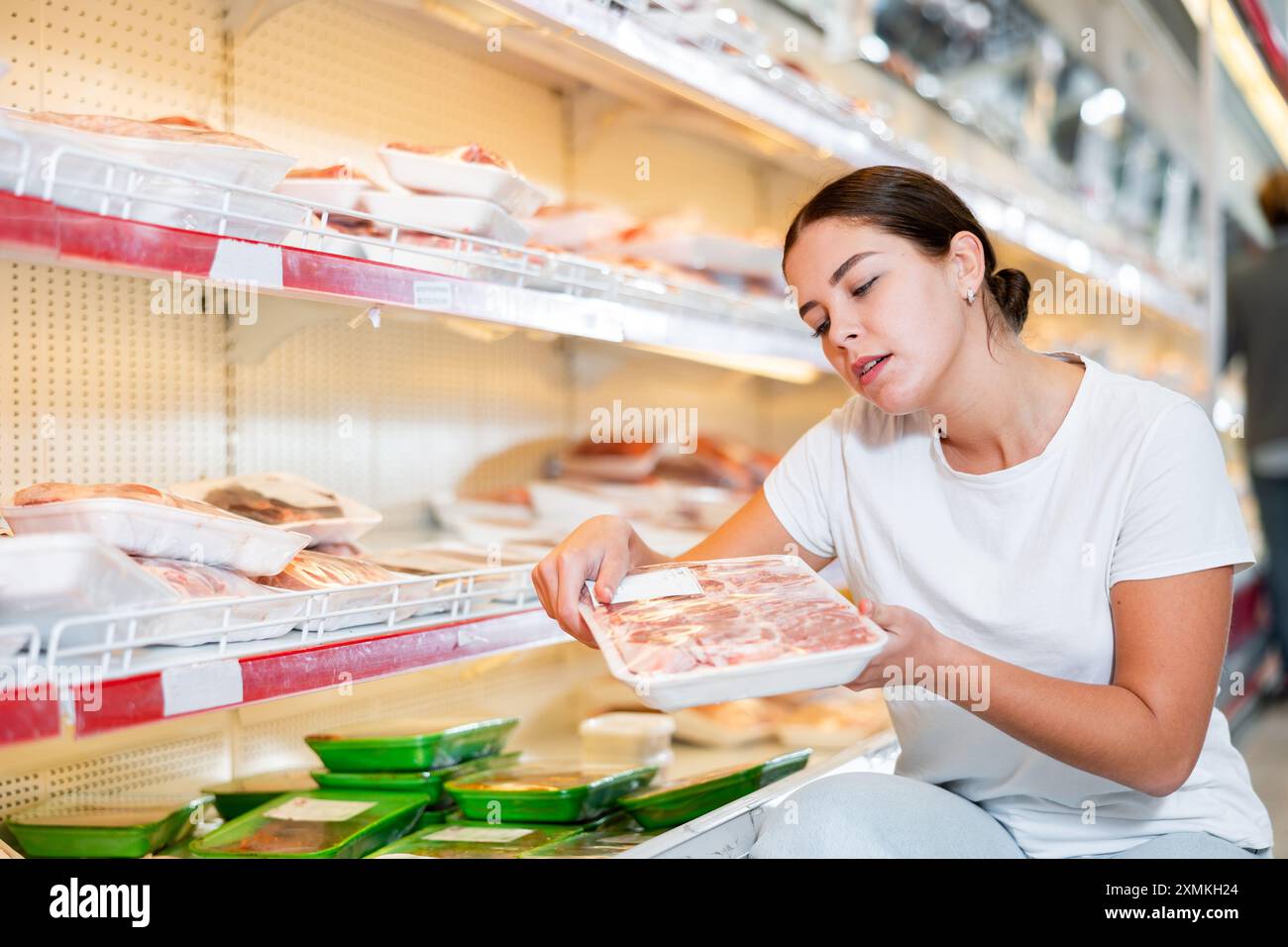 Woman choosing packaged mutton in supermarket Stock Photo - Alamy