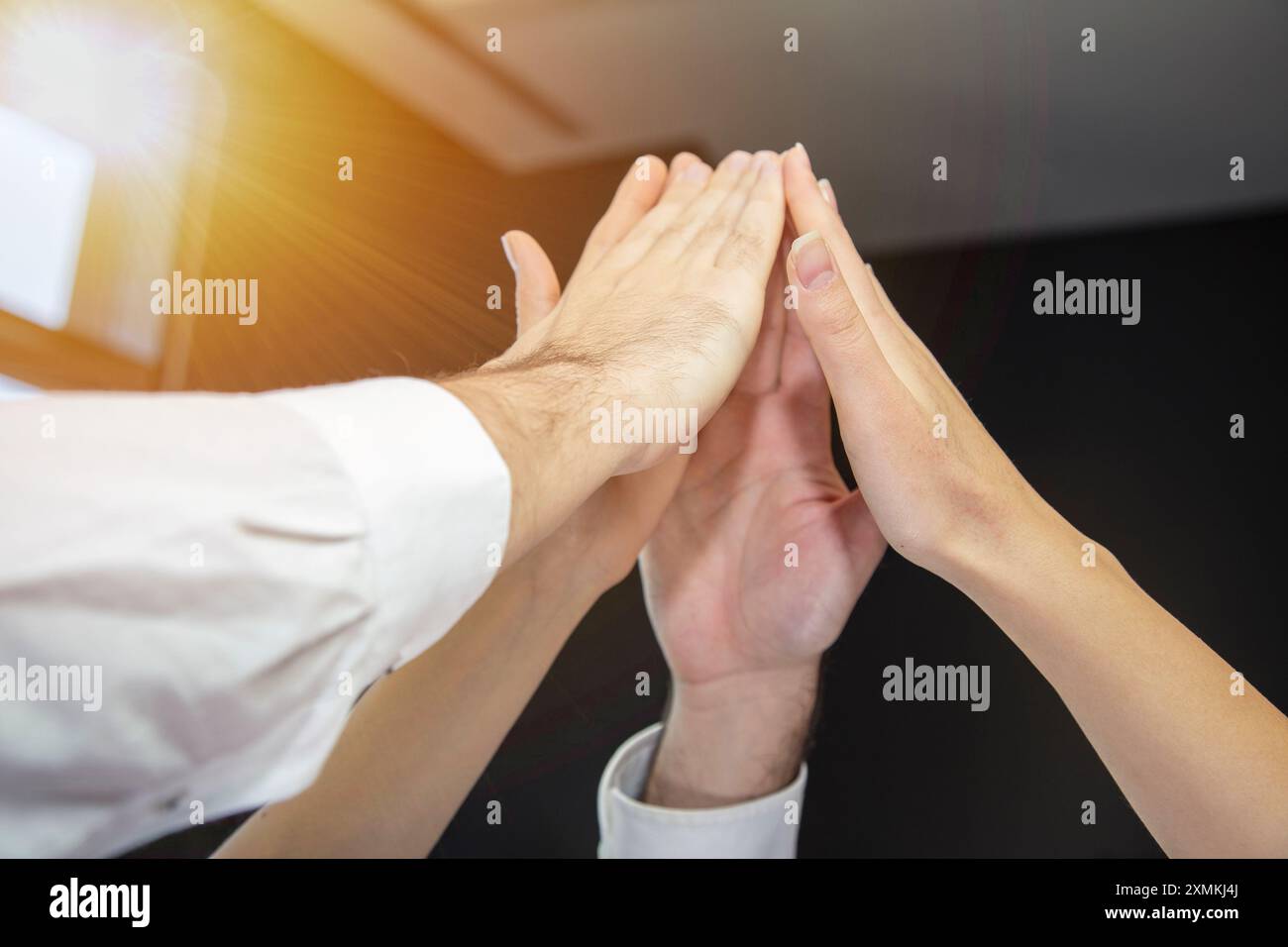 Three people are holding hands in a circle, symbolizing unity and ...