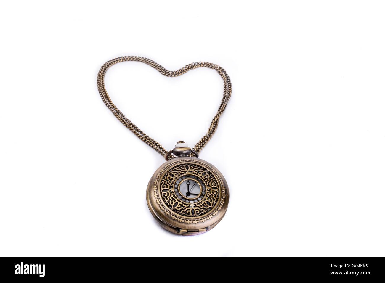 Retro styled pocket watch and its chain form a heart on a white ...