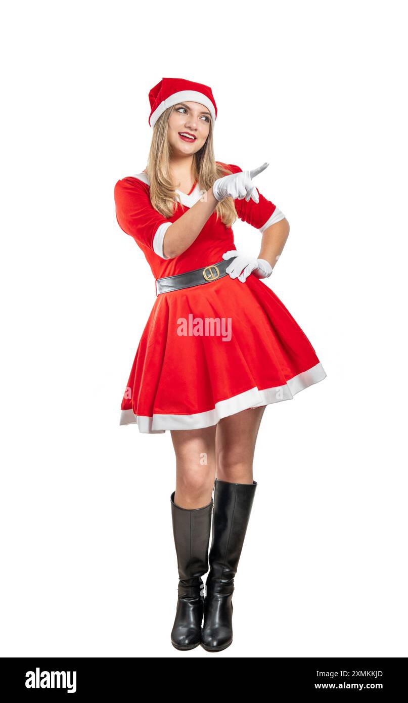 Full length young latina woman dressed as mama claus pointing with ...