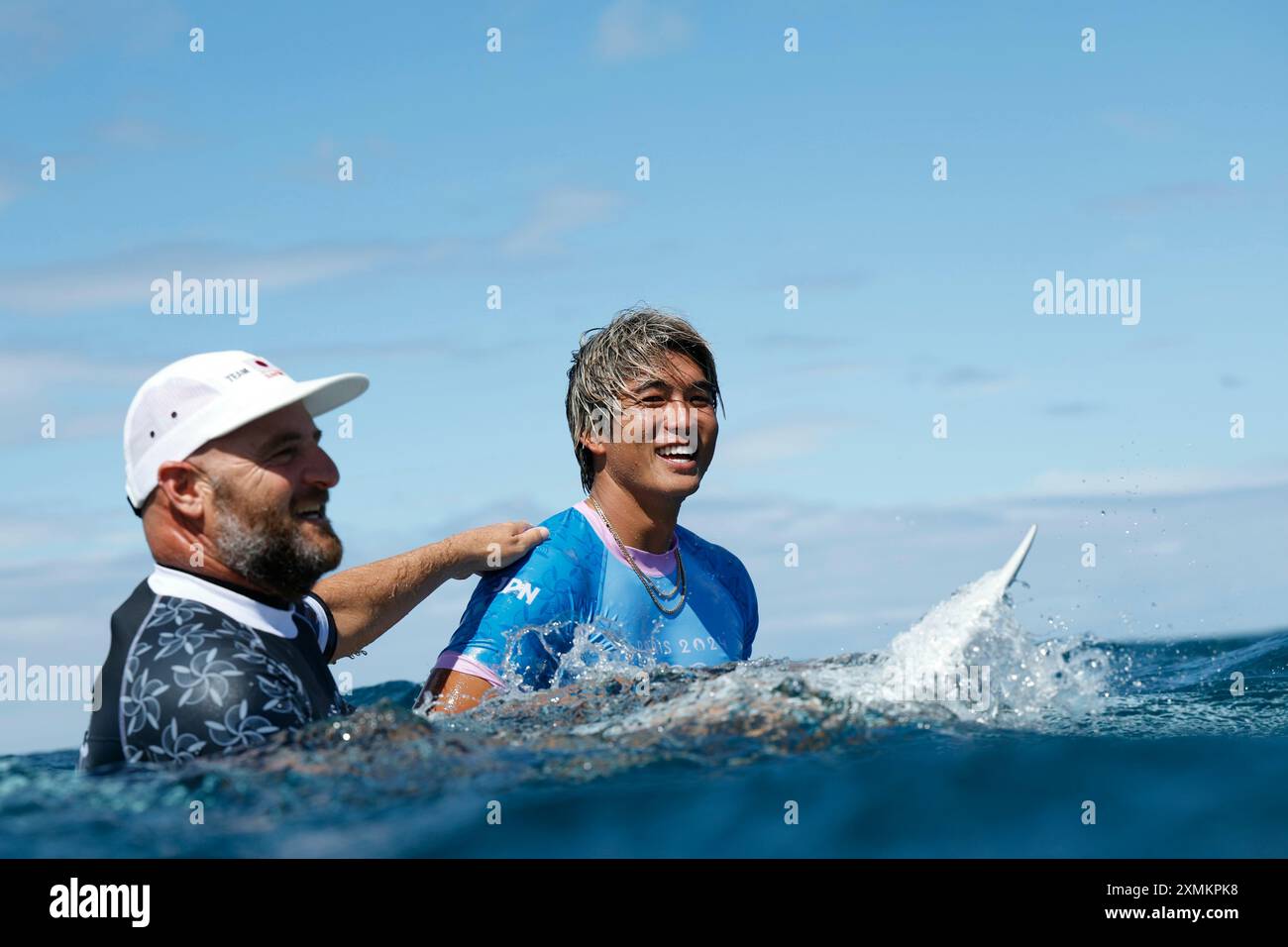 Kanoa Igarashi, of Japan, right, reacts with his coach during the ...