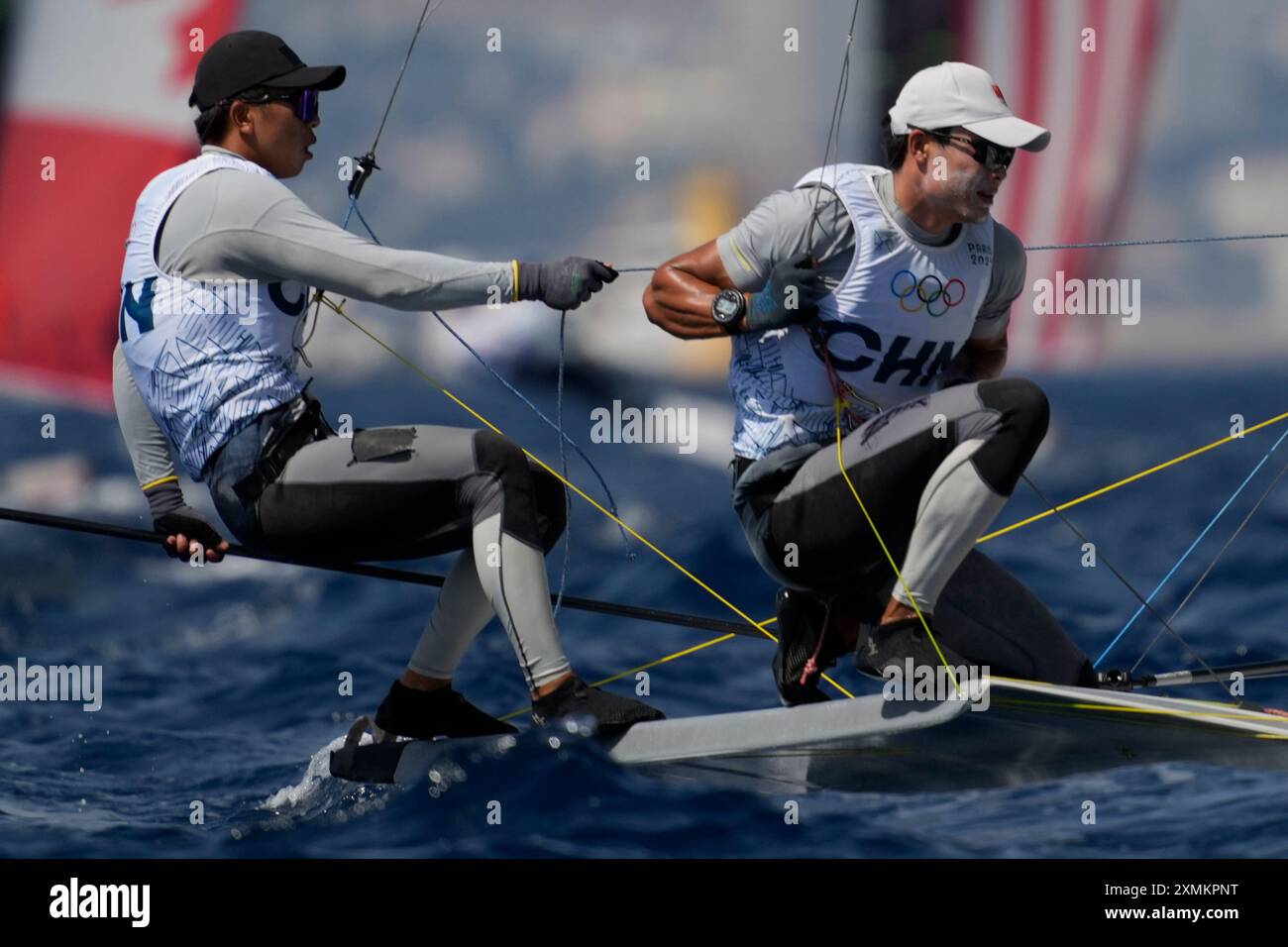 Wen Zaiding and Liu Tian of China prepare to round a mark during a men's 49er skiff class race ...