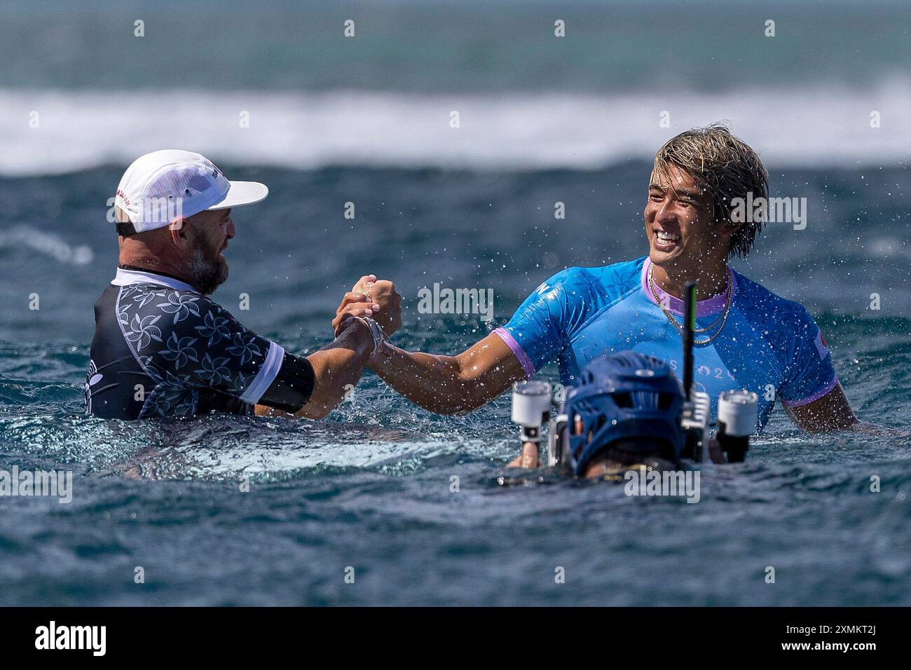Kanoa Igarashi, of Japan, celebrates with his coach following his heat ...