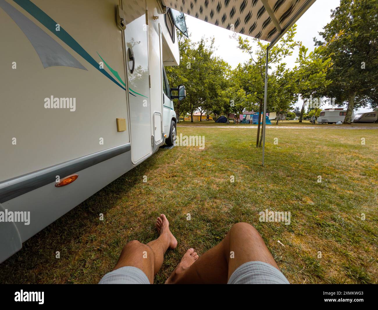 Relaxing sitting under the awning on the grass outside the motor home ...