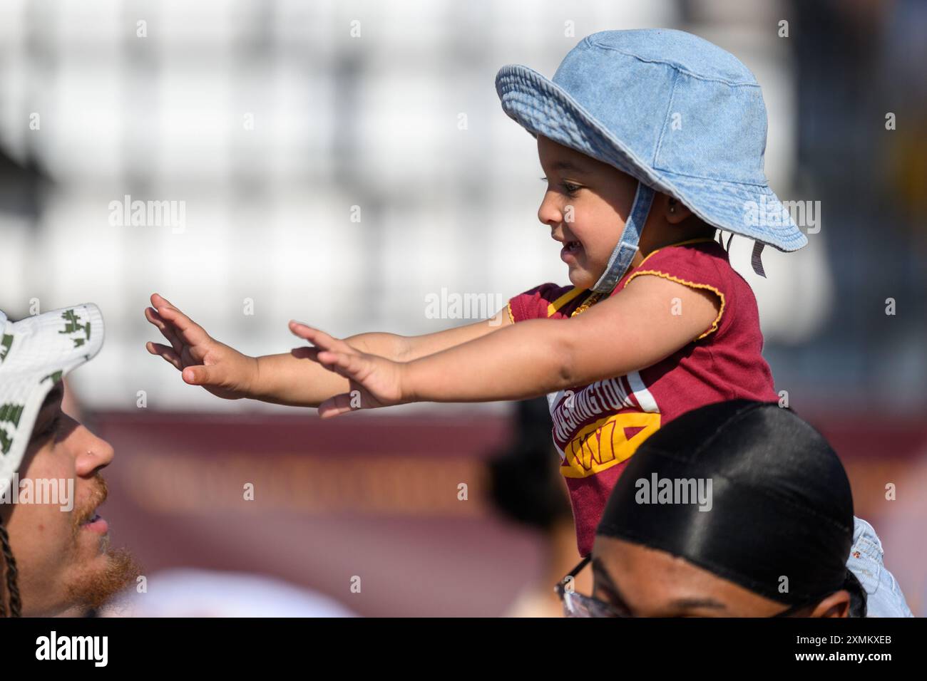 Ashburn, VA, USA. 28th July, 2024. A Washington Commanders fan looks on ...