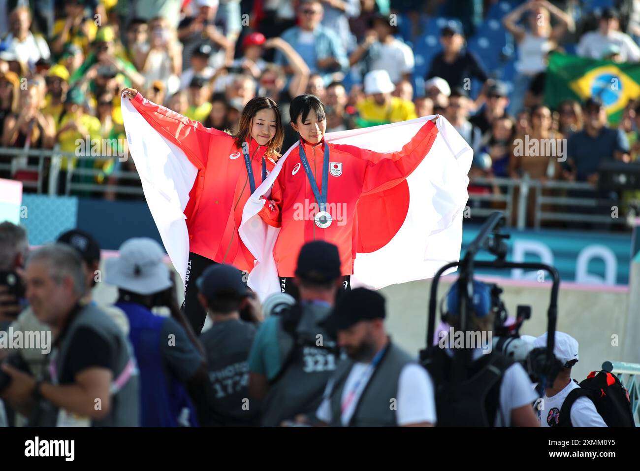 Coco YOSHIZAWA (L) and Liz AKAMA (R) pose for photographers while ...