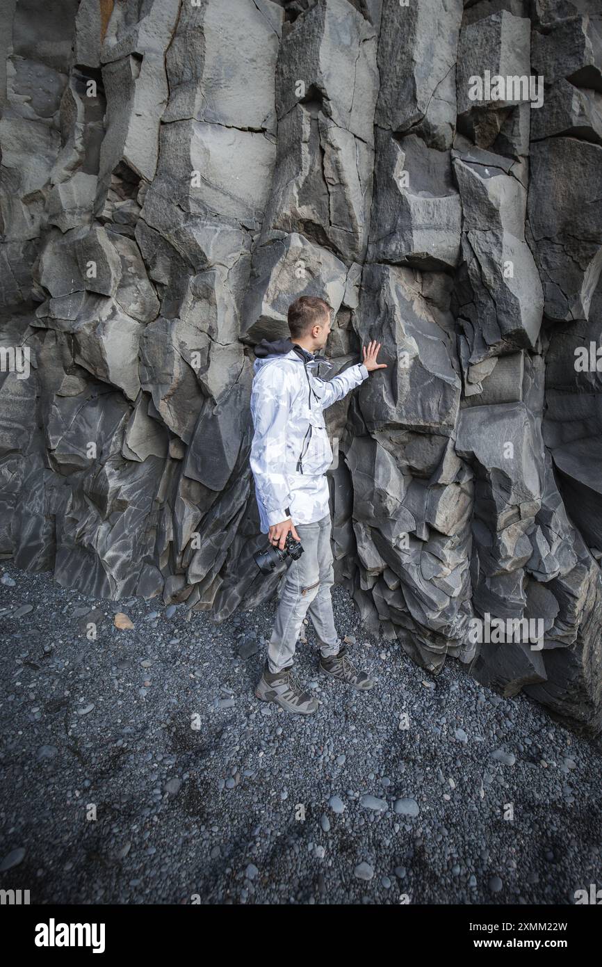 Person Exploring Hexagonal Basalt Columns in Volcanic Region of Iceland ...