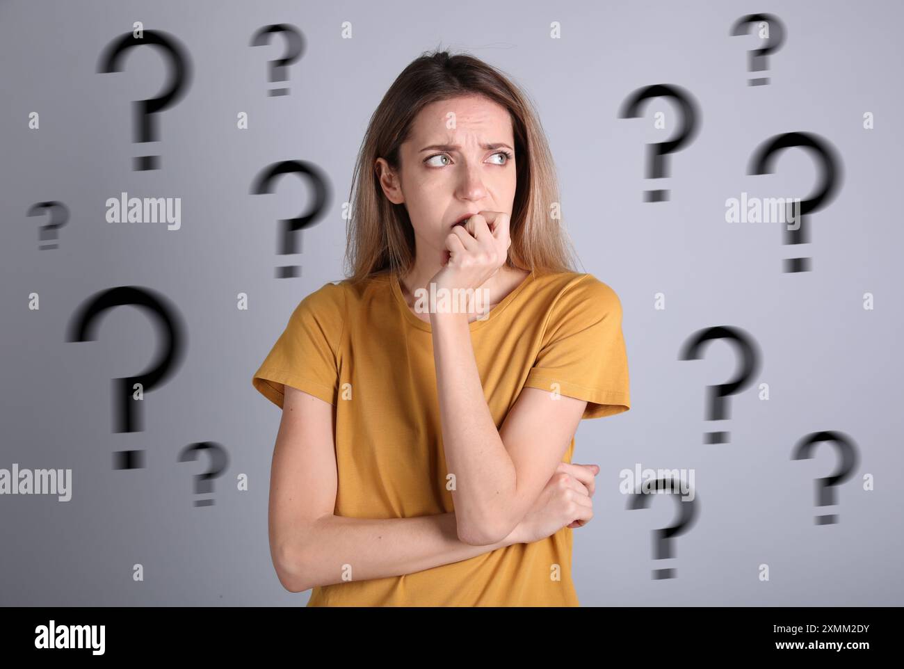 Amnesia. Worried woman and question marks on grey background Stock ...