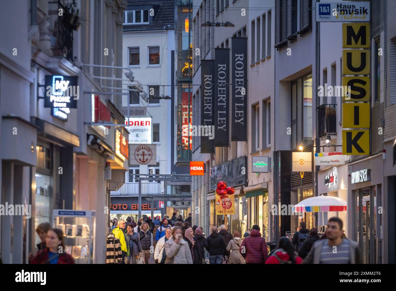 Picture of facades of a medieval street at dusk, with shops and ...