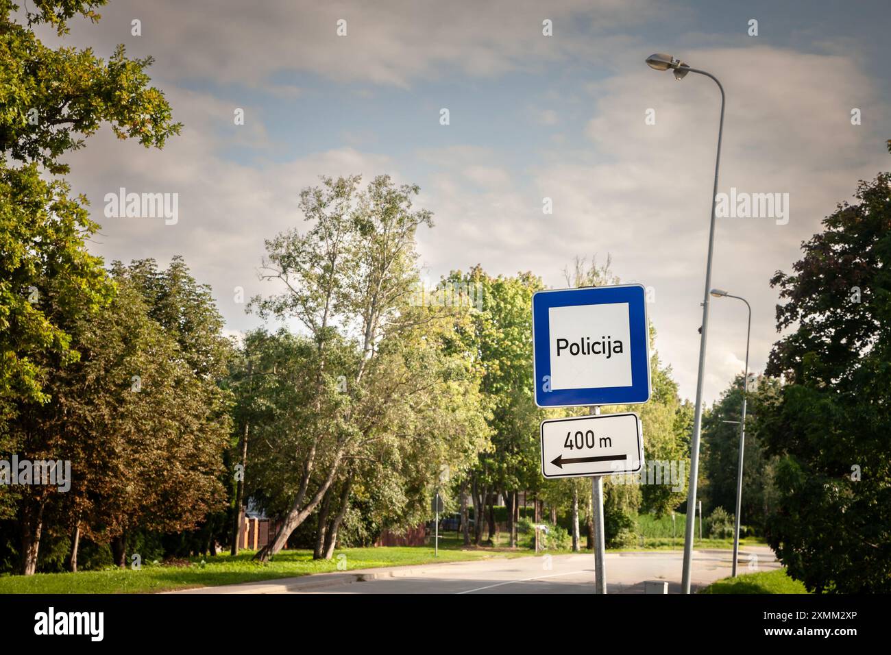 The image features a road sign indicating the nearest police station in ...