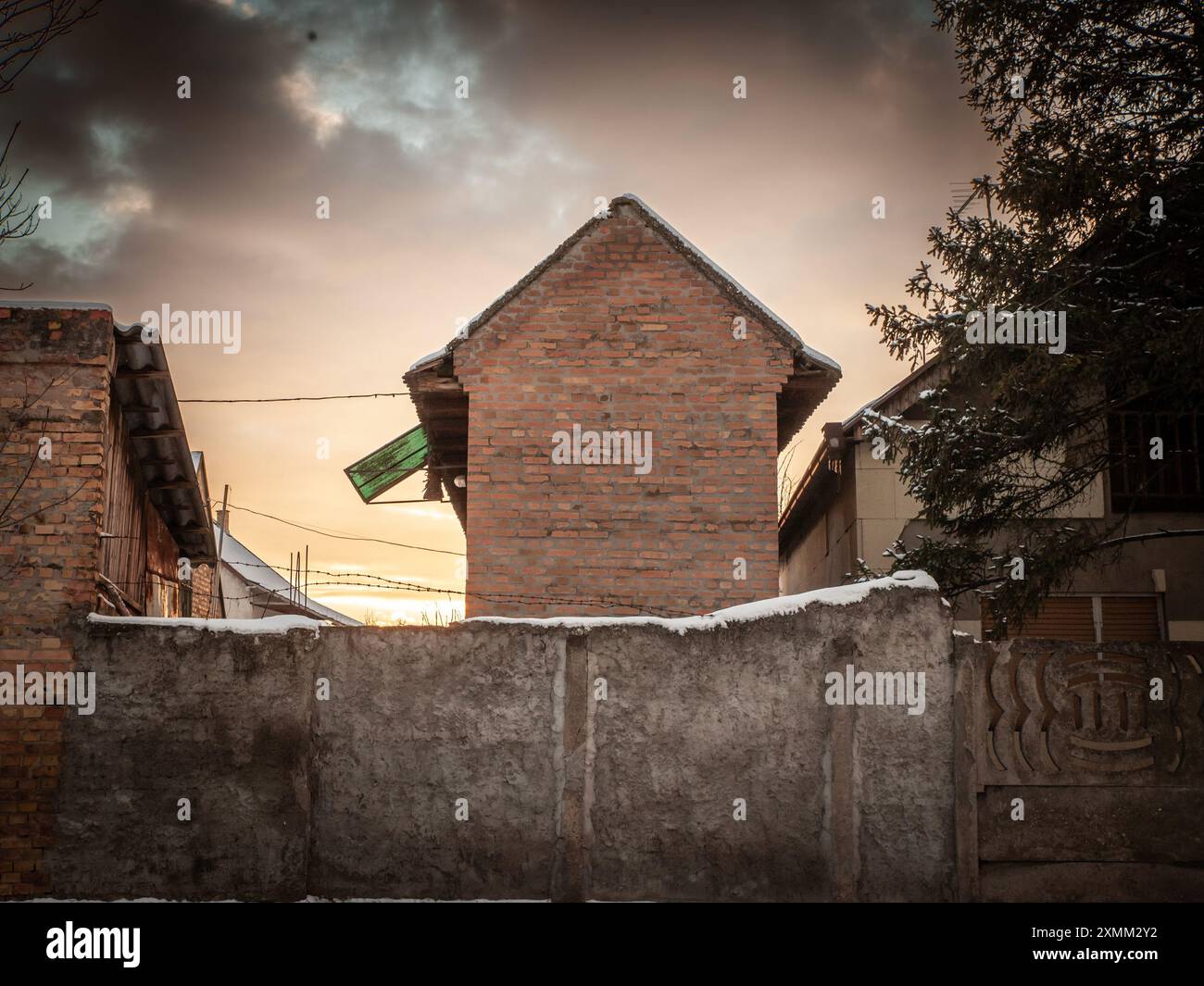 This photograph depicts a rustic farm scene in Serbia, showcasing a ...
